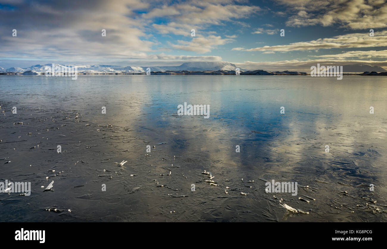 Frozen Lake with Volcano blue Sky and Snow reflection white in I Stock ...
