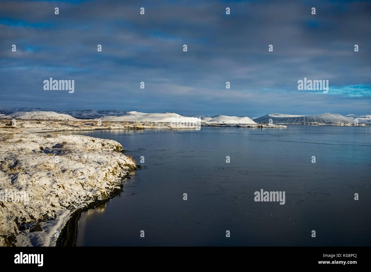 Frozen Lake with Volcano blue Sky and Snow reflection white in I Stock ...