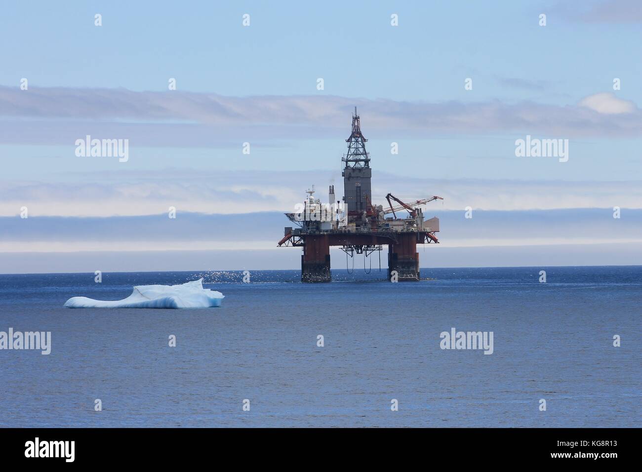 An Iceberg floating by an oil rig, Bay Bulls, Newfoundland and Labrador ...