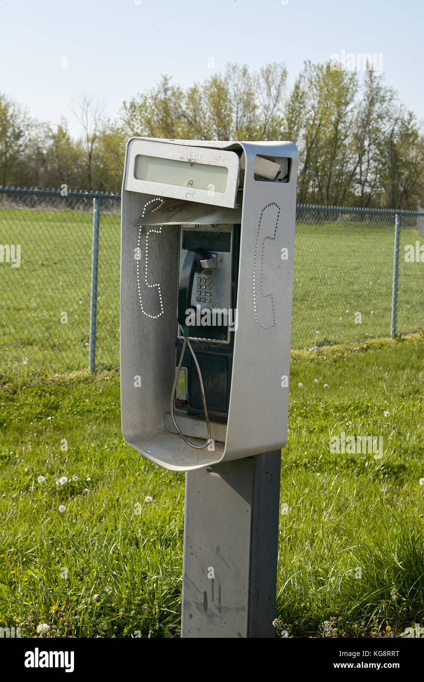 Outdoor telephone booth in a grassy rural field with a terrestrial ...