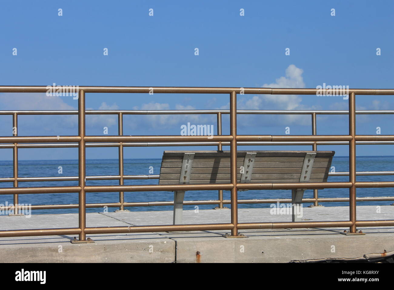 Park bench on the pier, overlooking the Gulf of Mexico, Treasure Island ...