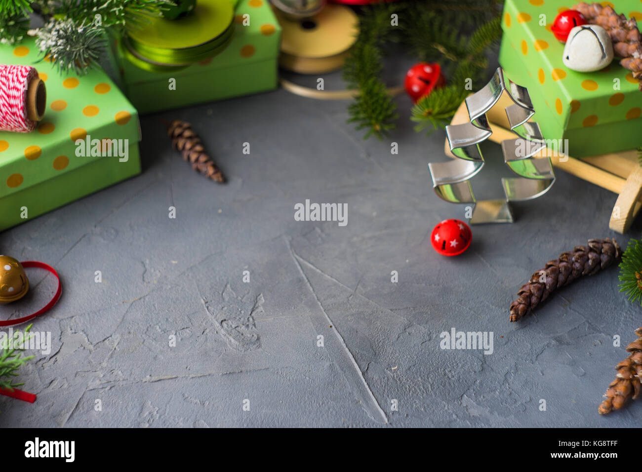 Christmas concept with gift boxes, ribbon and cones on rustic concrete ...
