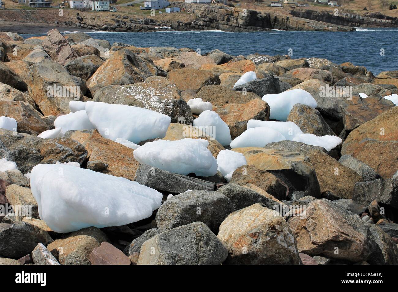 Pieces of ice among the large rocks on the beach, Flatrock ...