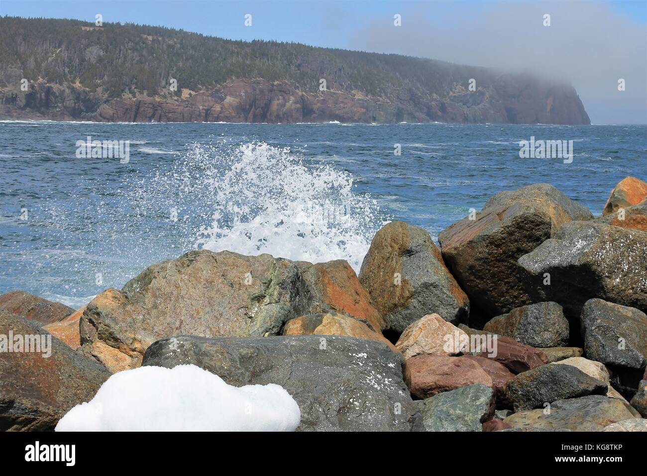 Pieces of ice among the large rocks on the beach, Flatrock ...