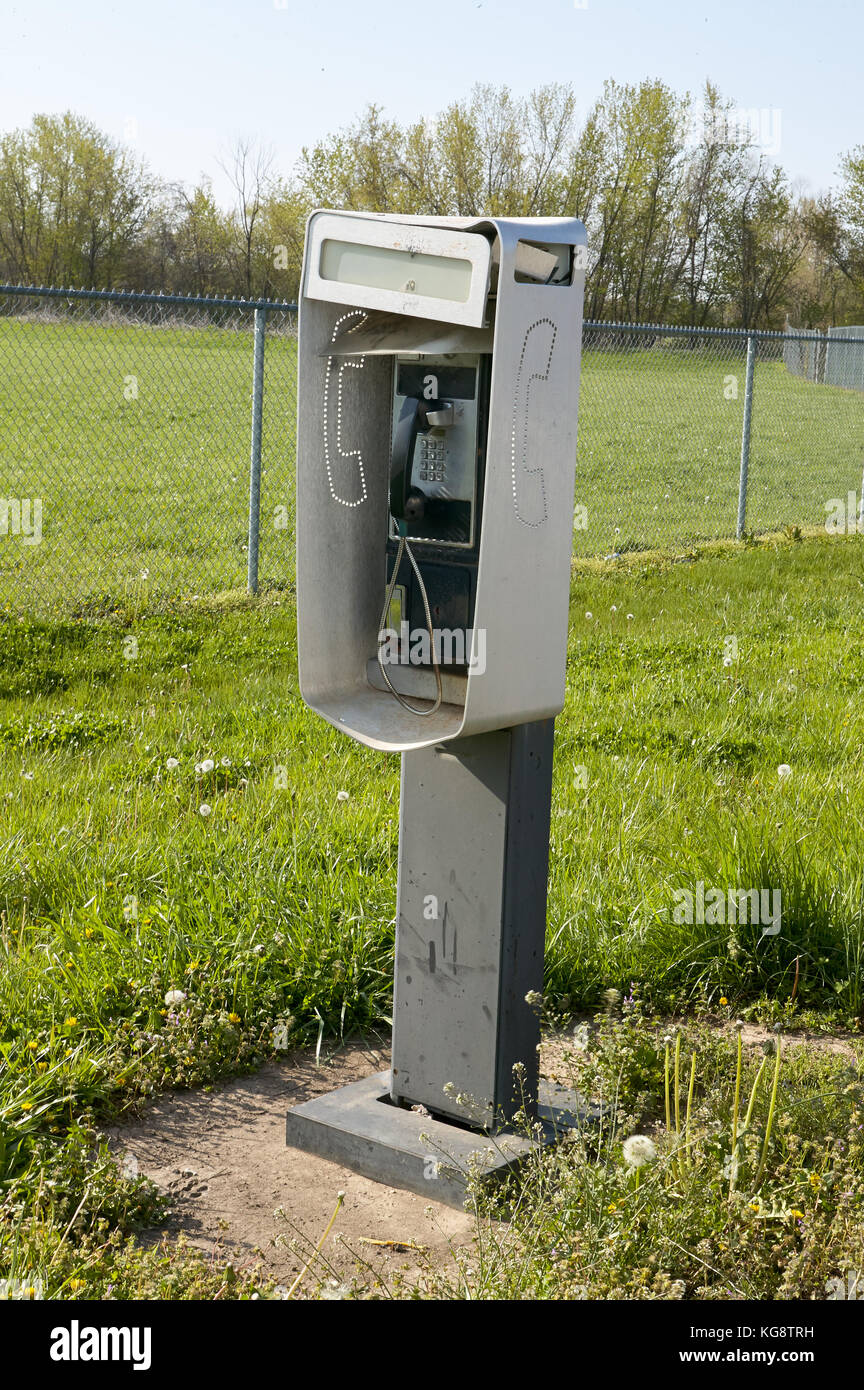 Small emergency or pay public phone booth in a rural field or pasture ...