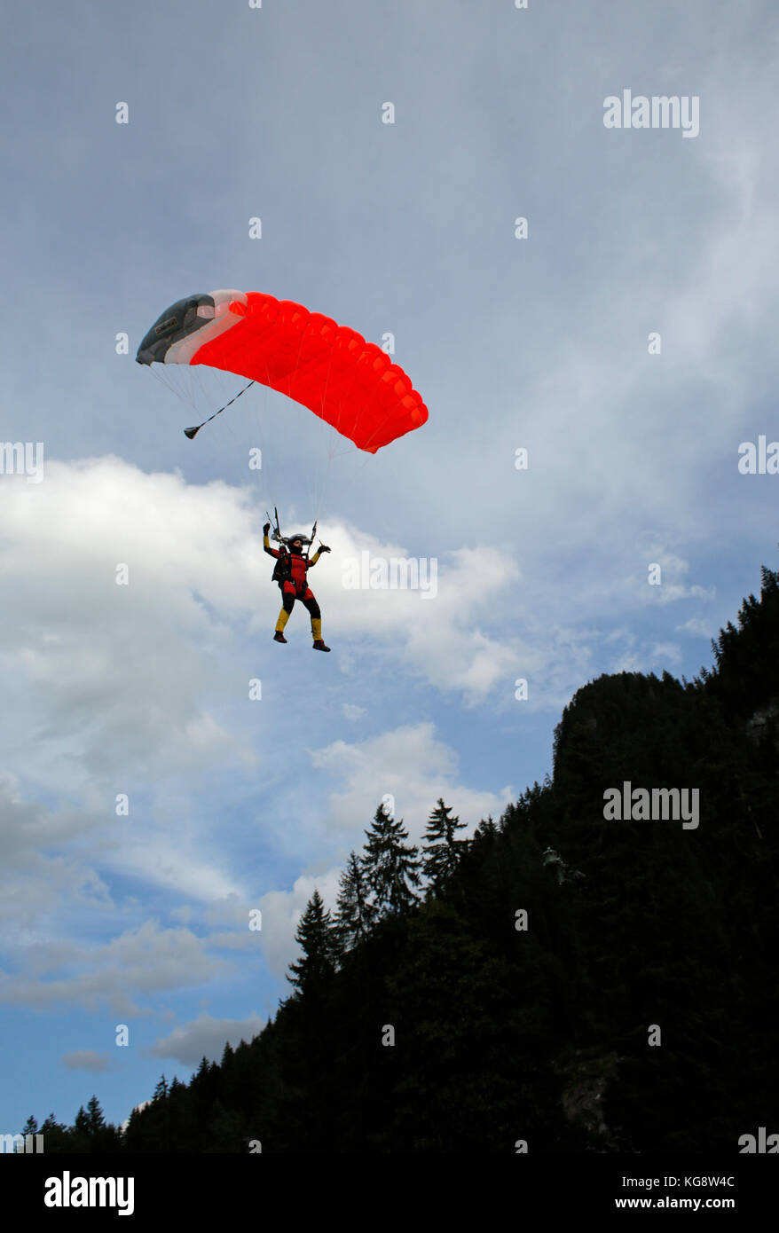 Skydiver under canopy is flying in the sky and approaching the landing ...