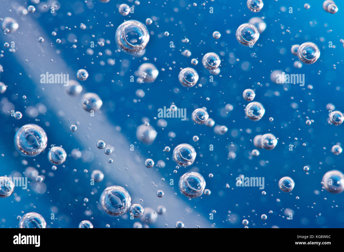 Large beautiful Oxygen bubbles underwater on a blue background macro ...