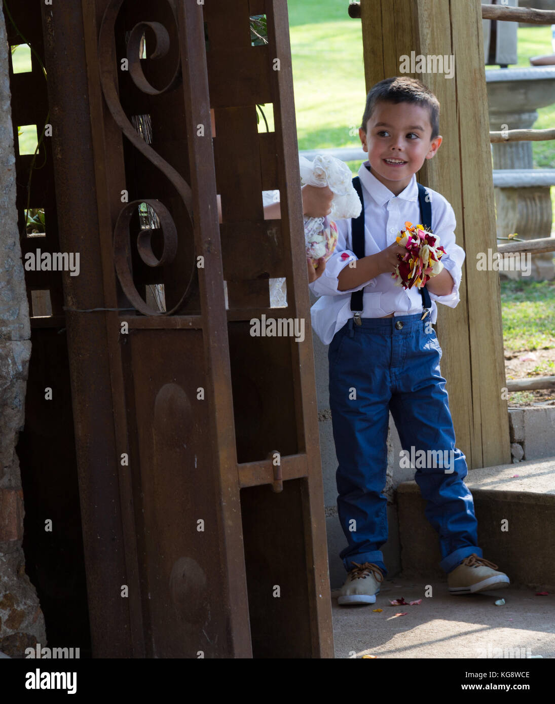 A pageboy waiting excitedly at the door of a church ready to throw ...