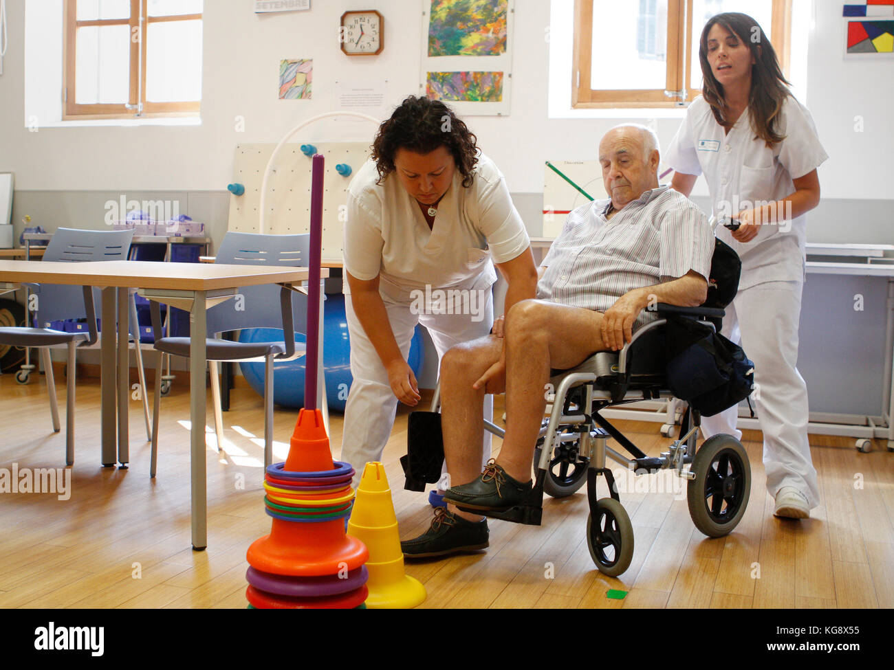 Patients who have suffered a stroke perform recovery activities with ...