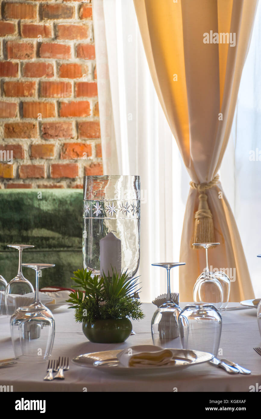 Table set in a luxurious restaurant with brick wall background Stock ...