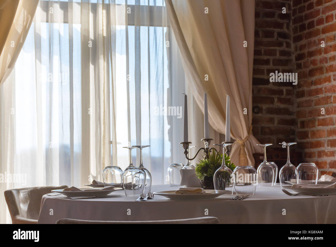 Table set in a luxurious restaurant with brick wall background Stock ...