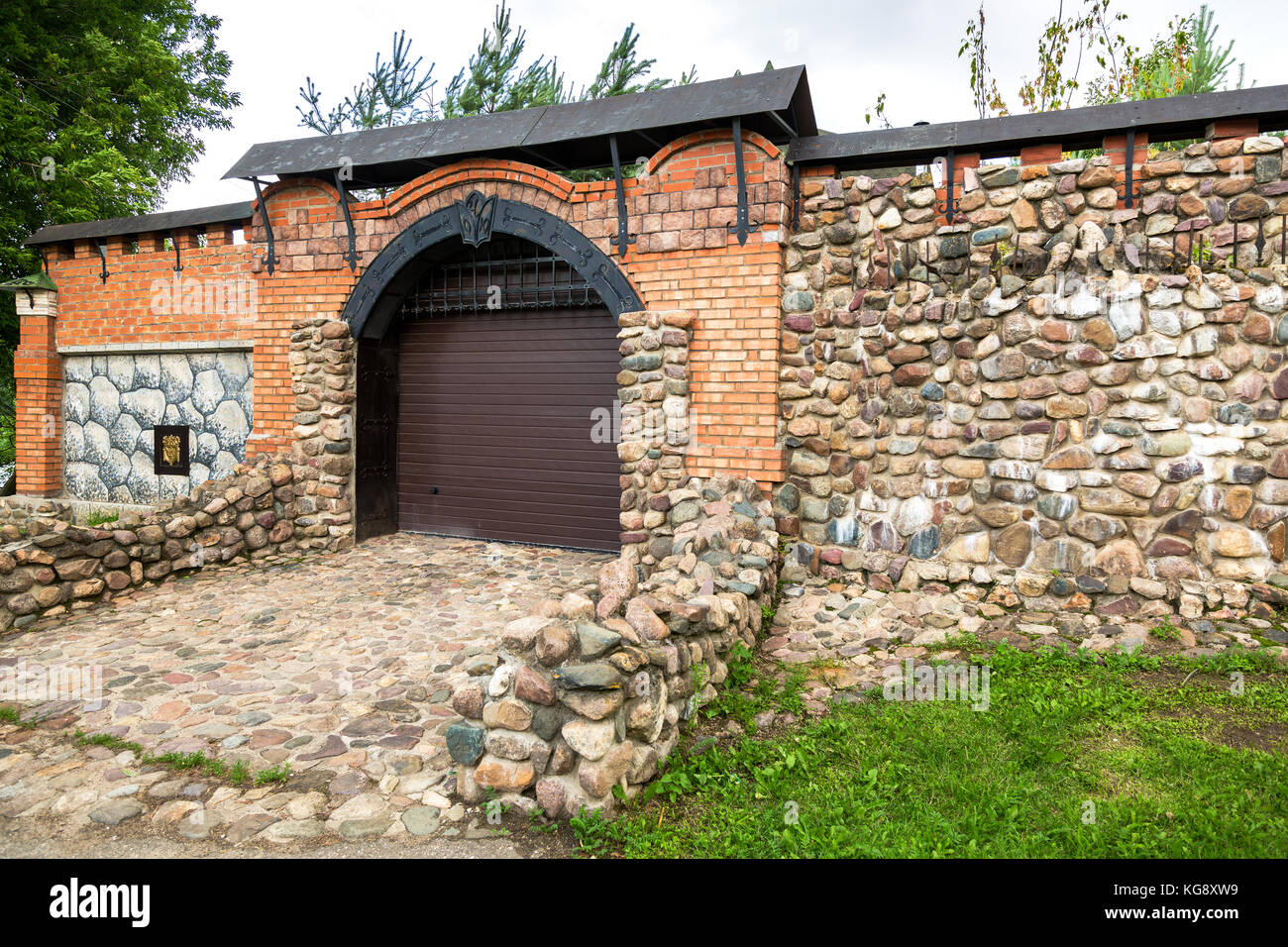 Big metal gate in the stone wall Stock Photo - Alamy