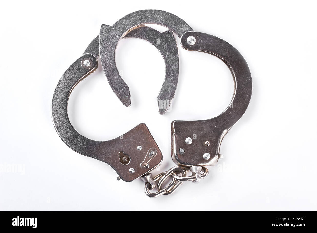 Metal handcuffs with clipping path Stock Photo - Alamy