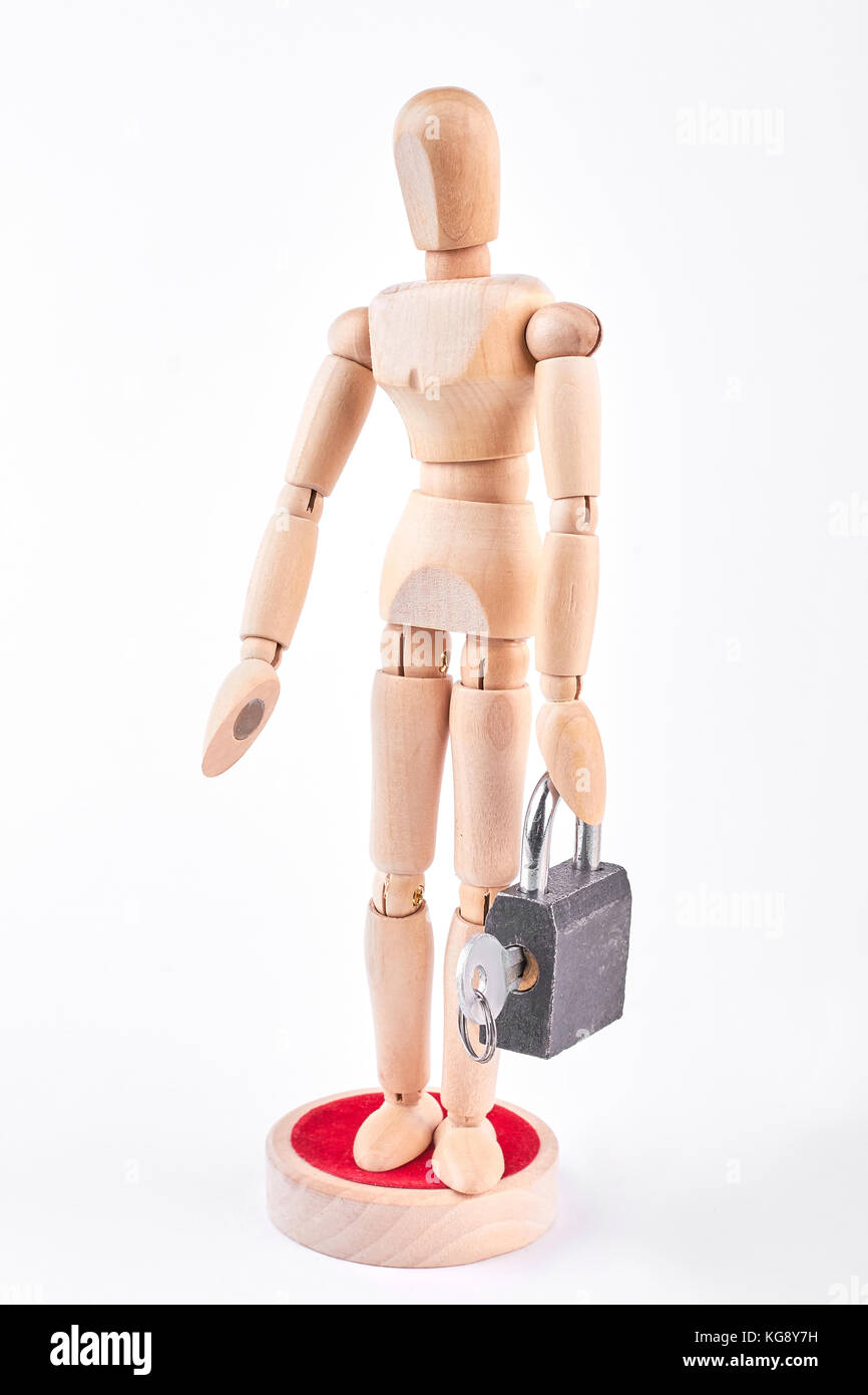 Wooden dummy holding padlock in hand Stock Photo - Alamy