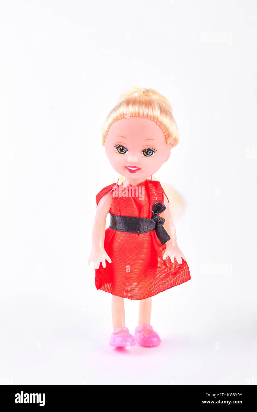 Doll in red dress on white background Stock Photo - Alamy