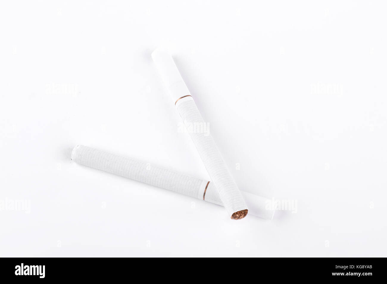 Two white cigarettes on white background Stock Photo - Alamy