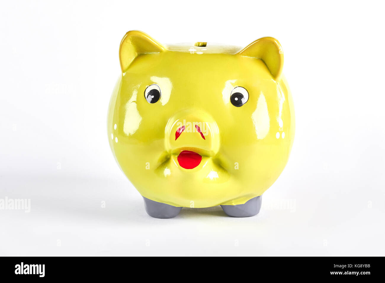 Yellow piggy bank isolated over white Stock Photo - Alamy
