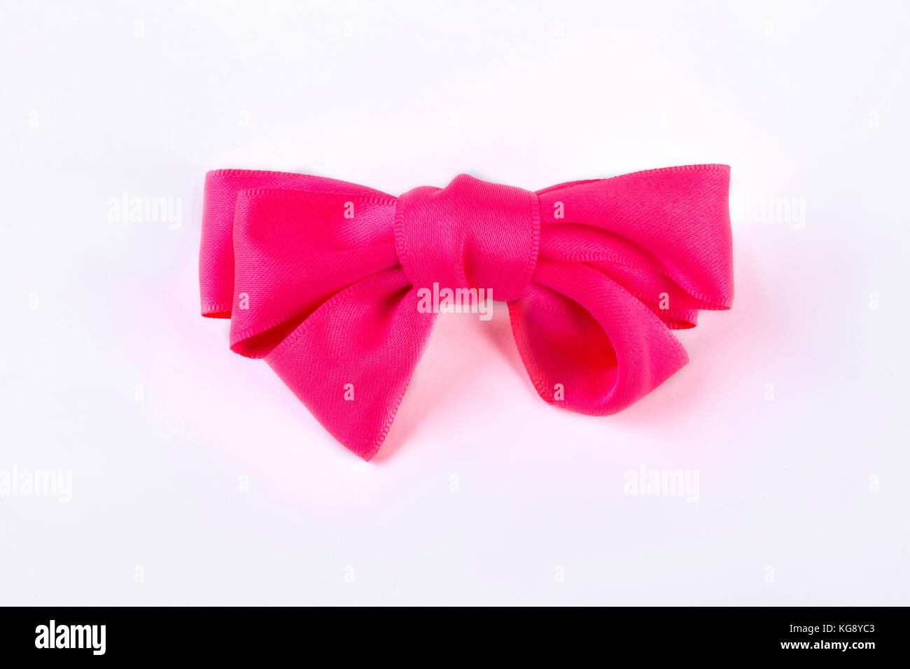 Pink bow tie on white background Stock Photo - Alamy