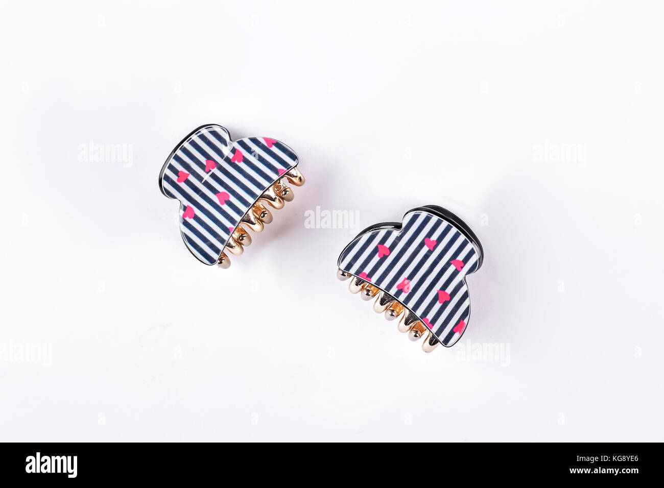 Two stylish hair clips on white background Stock Photo - Alamy