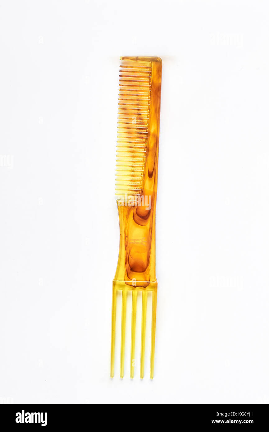 Barber amber color plastic comb Stock Photo - Alamy