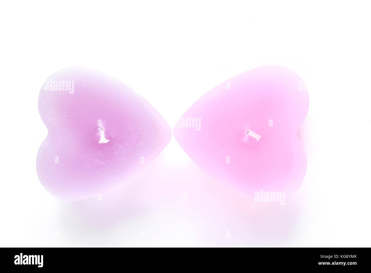 Two colored candles on white background Stock Photo - Alamy