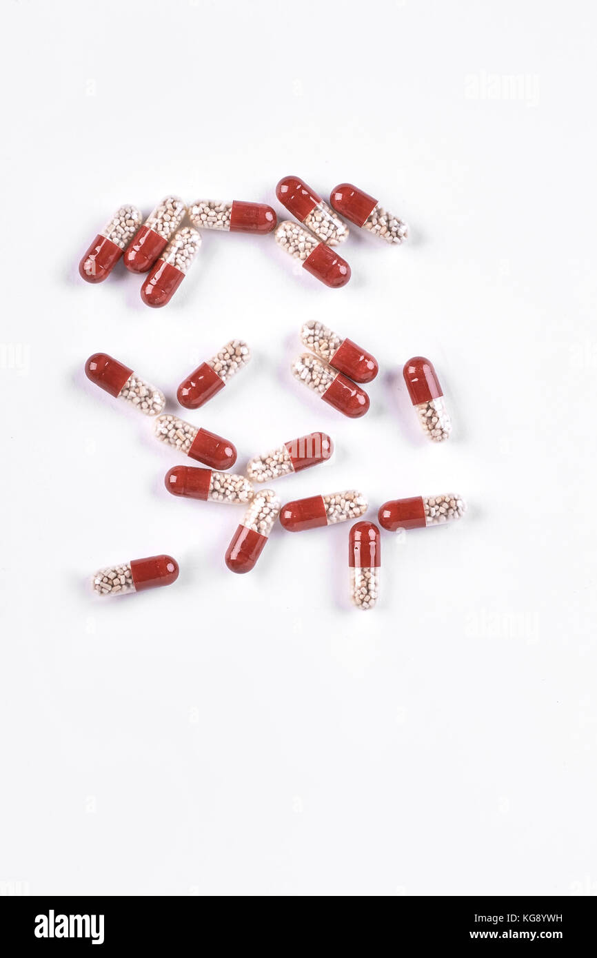 Scattered capsules on white background Stock Photo - Alamy