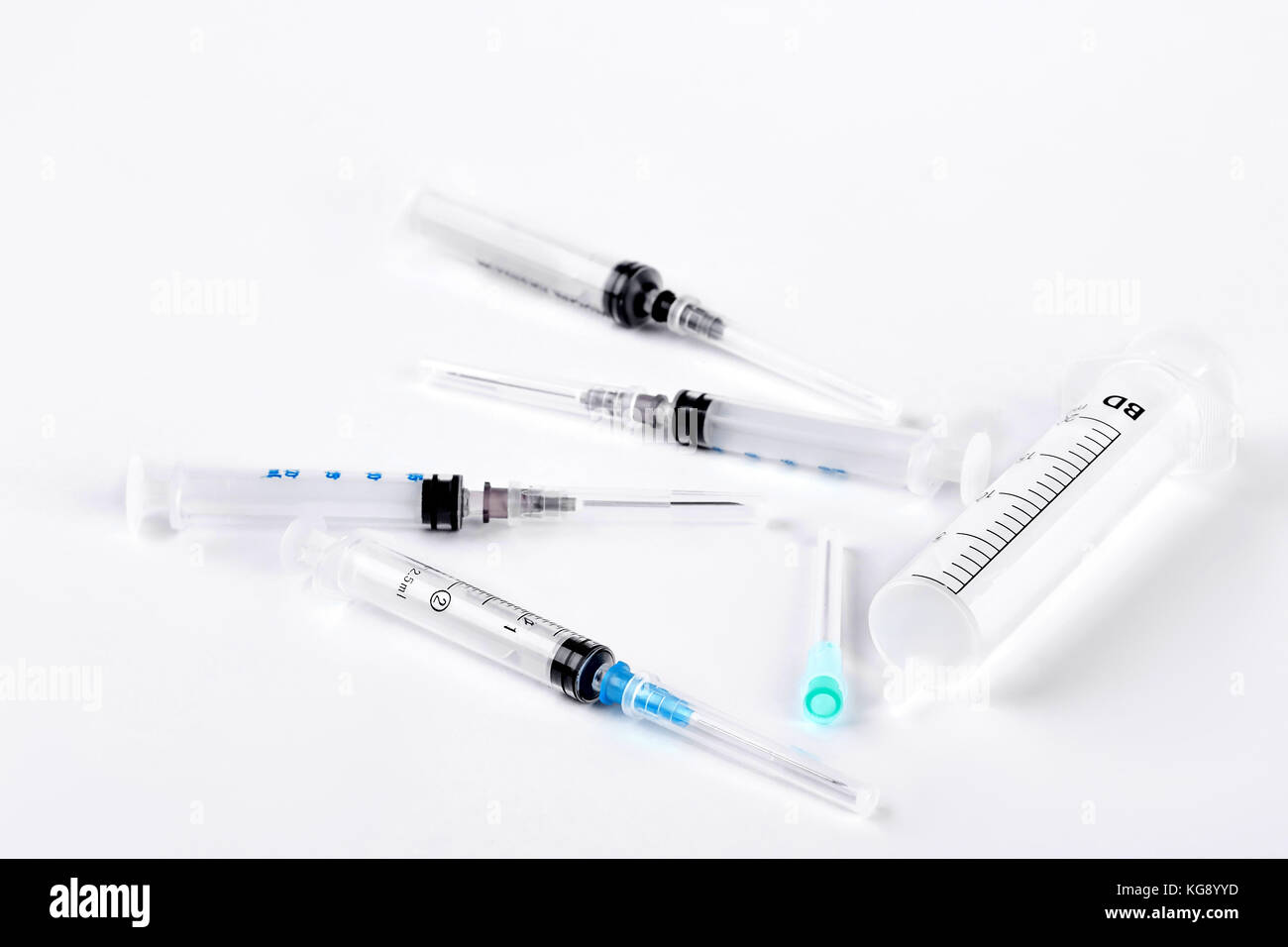 Plastic syringes on white background Stock Photo - Alamy
