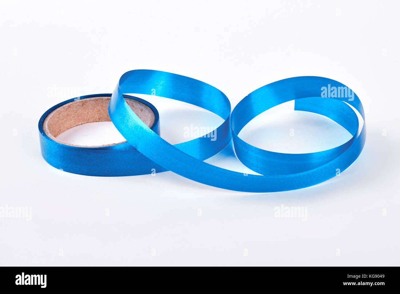 Roll of blue ribbon on white background Stock Photo - Alamy