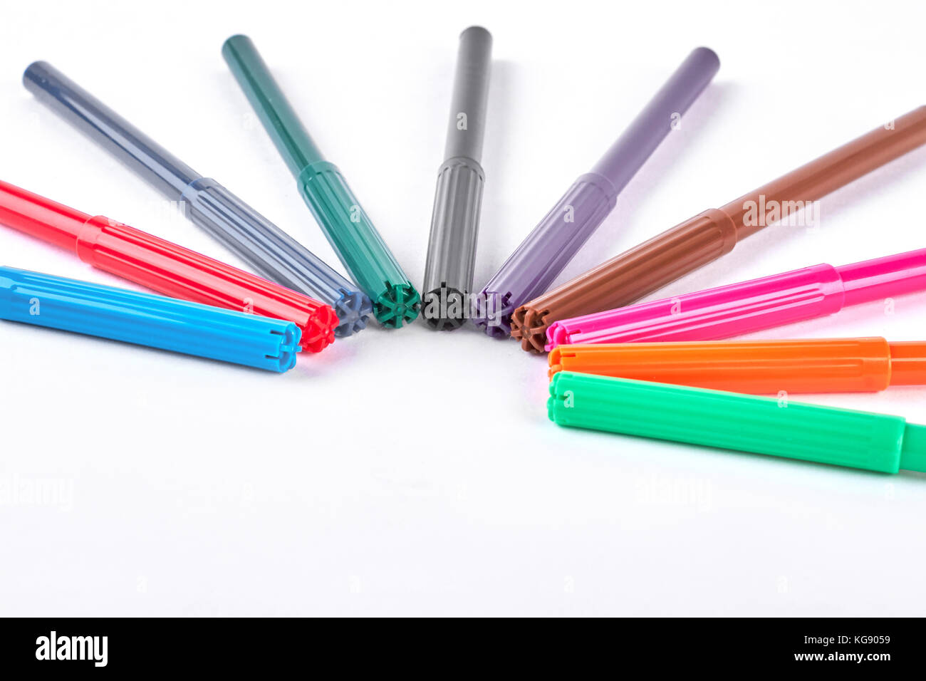 Different color markers on white background Stock Photo - Alamy