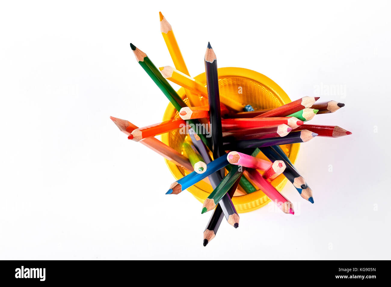 Colored pencils in yellow basket Stock Photo - Alamy