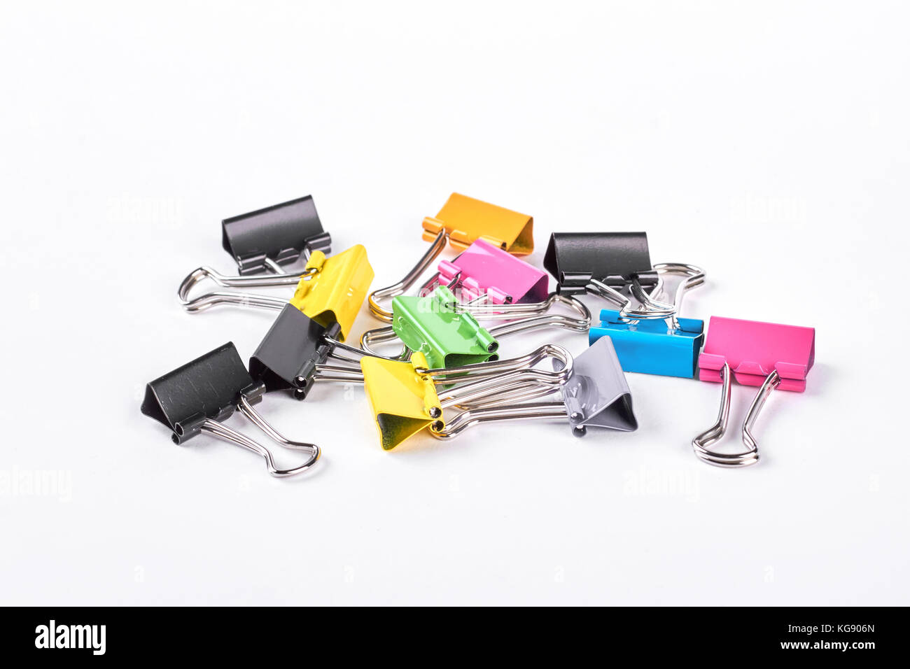 Many binder clips on white background Stock Photo - Alamy