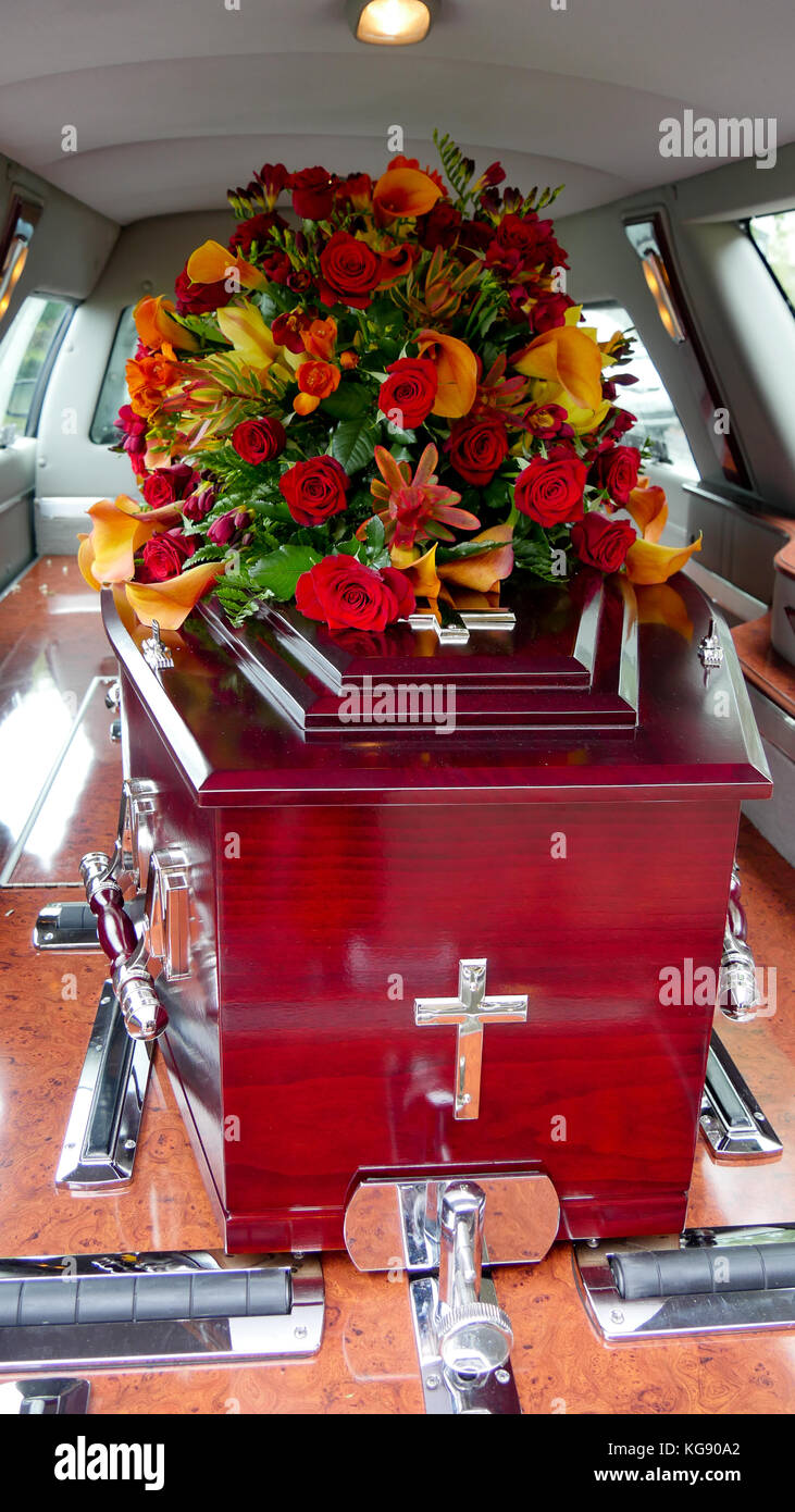 closeup shot of a colorful casket in a hearse or chapel before funeral ...