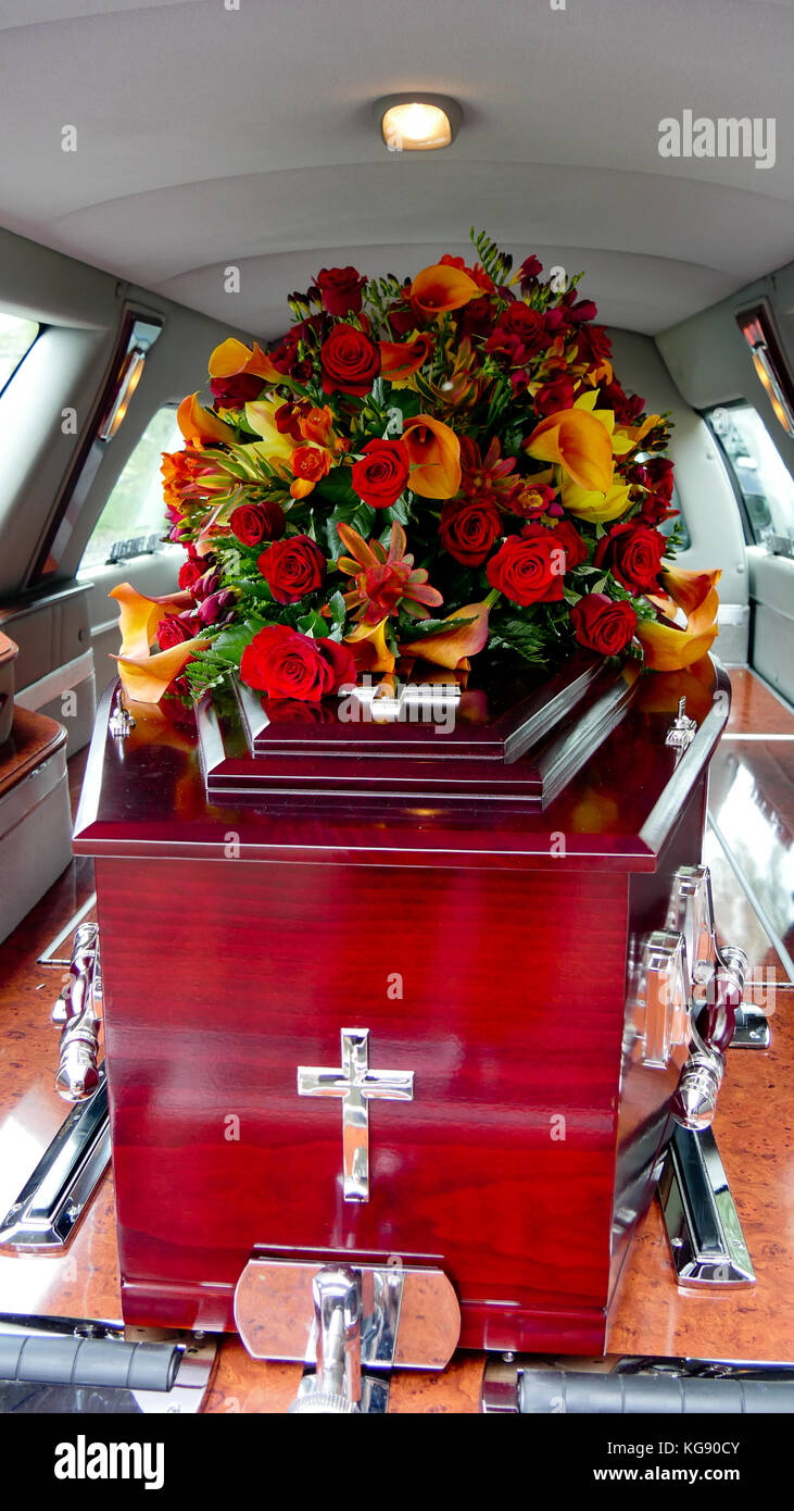 closeup shot of a colorful casket in a hearse or chapel before funeral ...