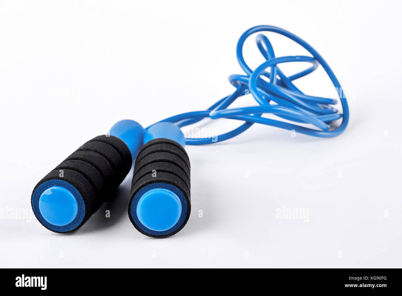 Blue skipping rope on white background Stock Photo - Alamy
