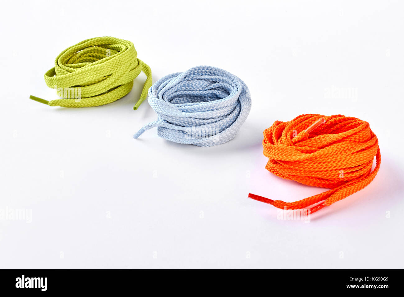 Rolls of colorful shoe laces, white background Stock Photo - Alamy