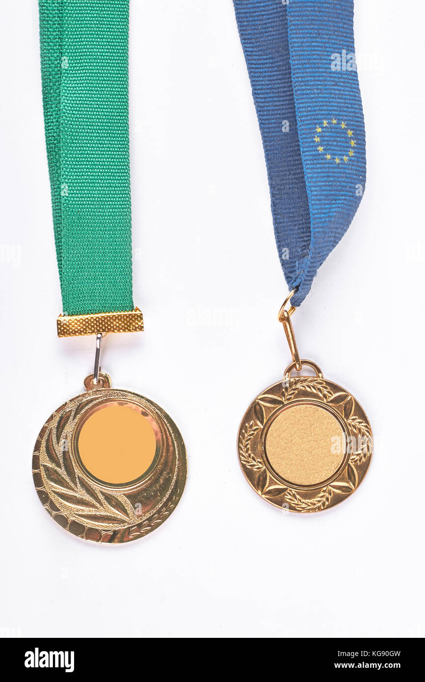 Two golden medals hanging on tapes Stock Photo - Alamy