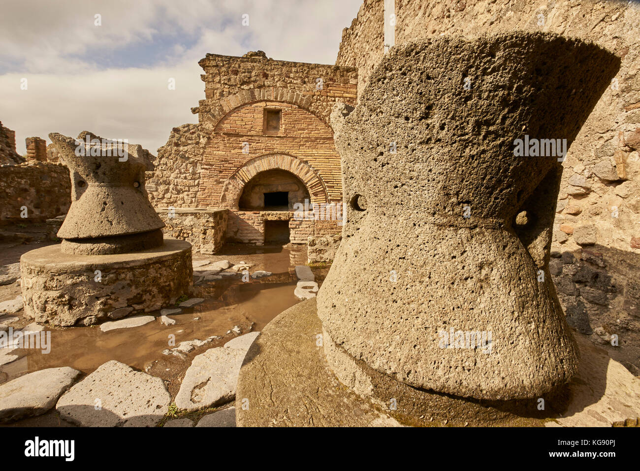 Pompeii ruins exhibited after archaeological excavations. Bakery with ...