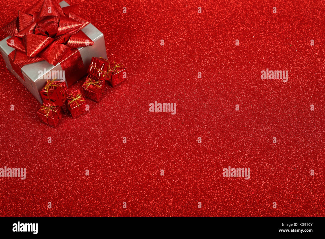 Christmas Gift Boxes on shiny red glitter background Stock Photo - Alamy