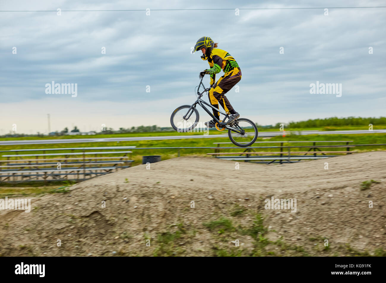Full length side view of a professional off-road bicyclist jumping with ...
