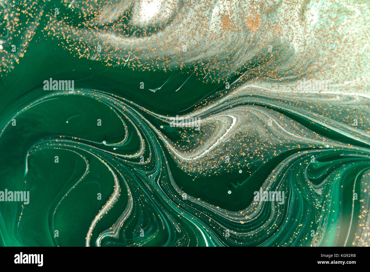 Marbled green abstract background with golden sequins. Liquid marble ...
