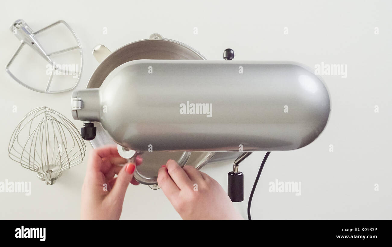 Setting up electric silver food mixer for baking Stock Photo - Alamy