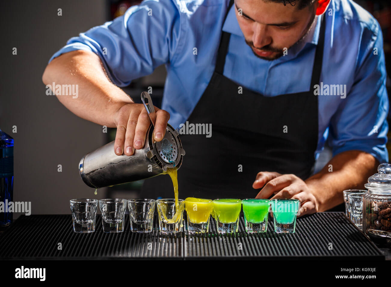 Barman is preparing Rainbow color shots Stock Photo - Alamy
