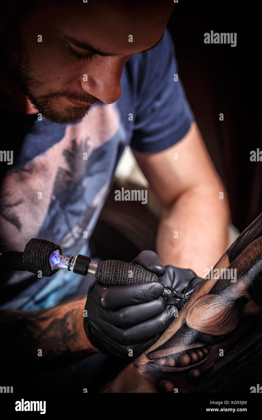 Tattoo artist demonstrates process hi-res stock photography and images ...