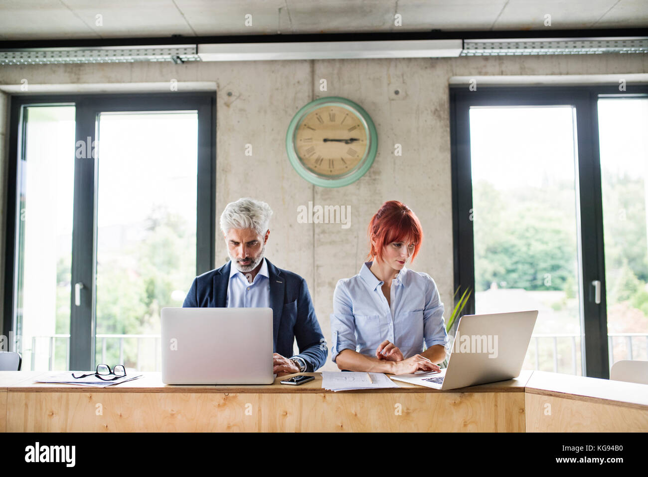 Business people in the office consulting a project Stock Photo - Alamy