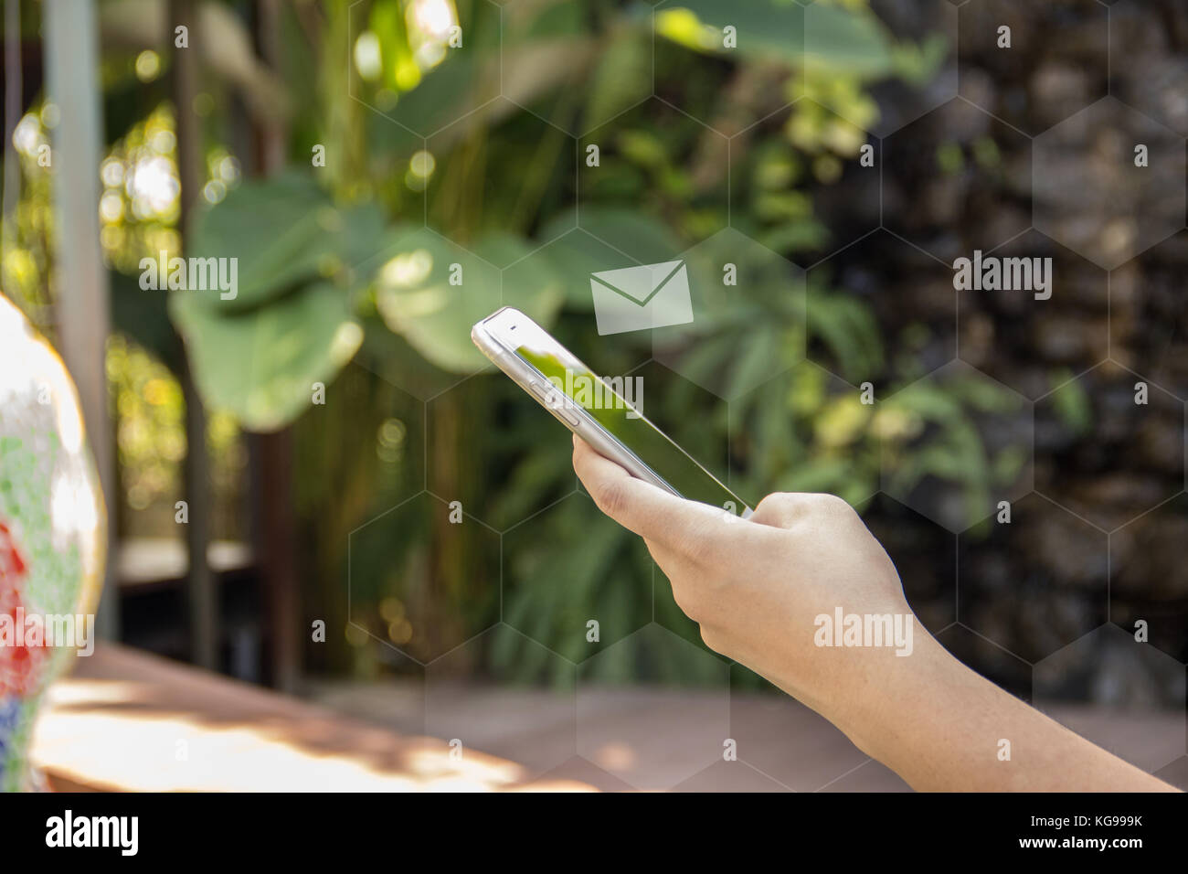 Hand hold smart phone and sent or receive email. email icon over phone ...