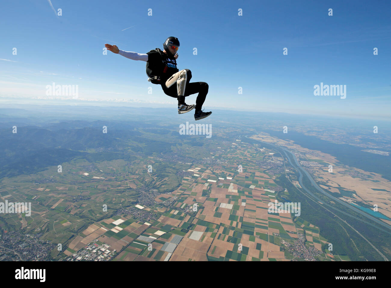 This Skydiver is training the sitfly position high in the sky. Thereby ...