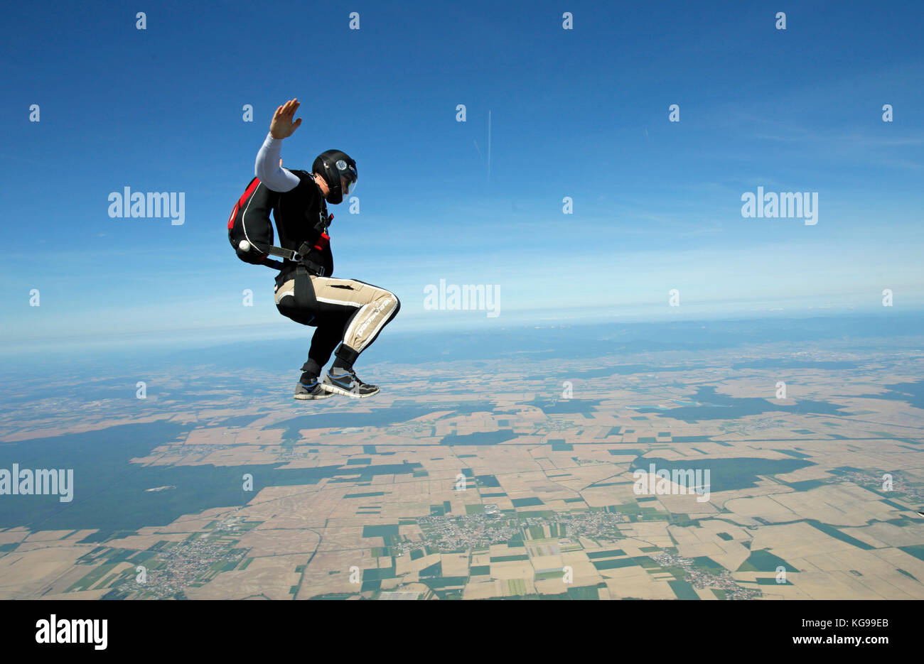 This Skydiver is training the sitfly position high in the sky. Thereby ...