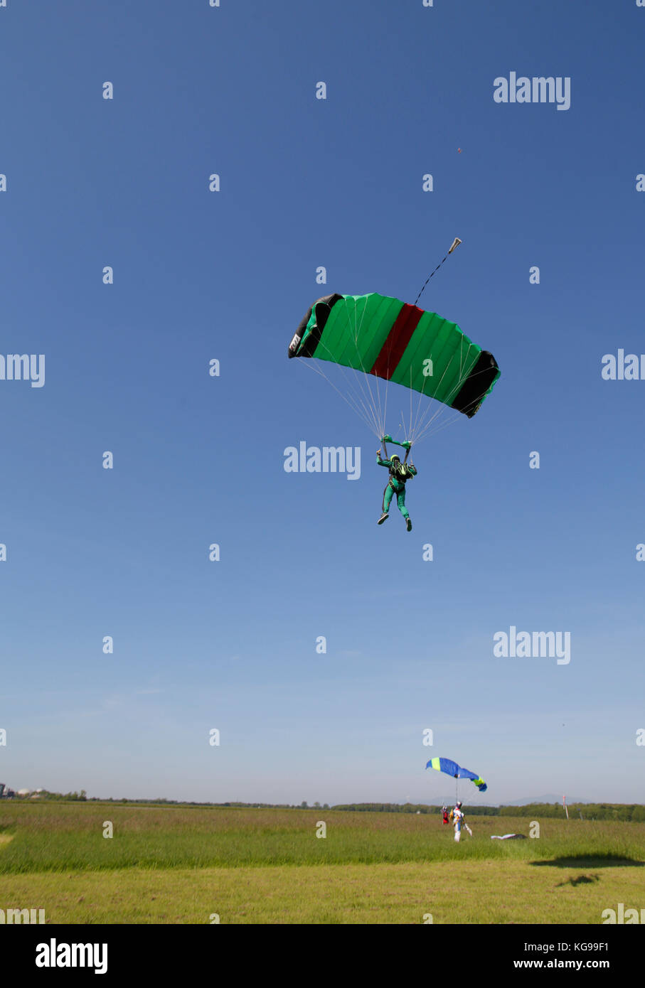 This skydiver is flying under his canopy in the sky. Soon he is going ...