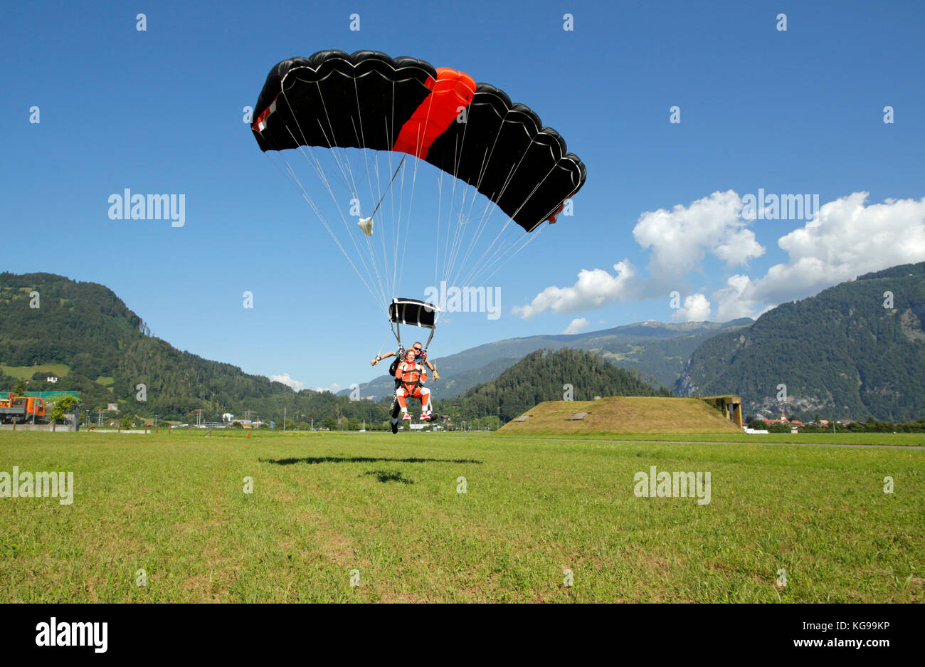 This tandem skydiving couple is landing together the parachute at the ...