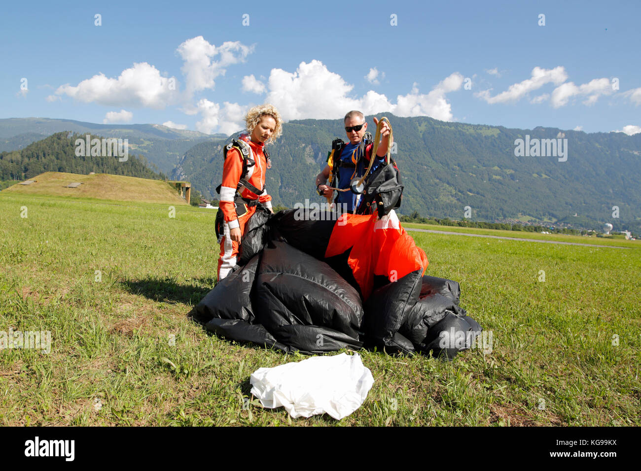 This tandem skydiving couple just landed together the parachute at the ...